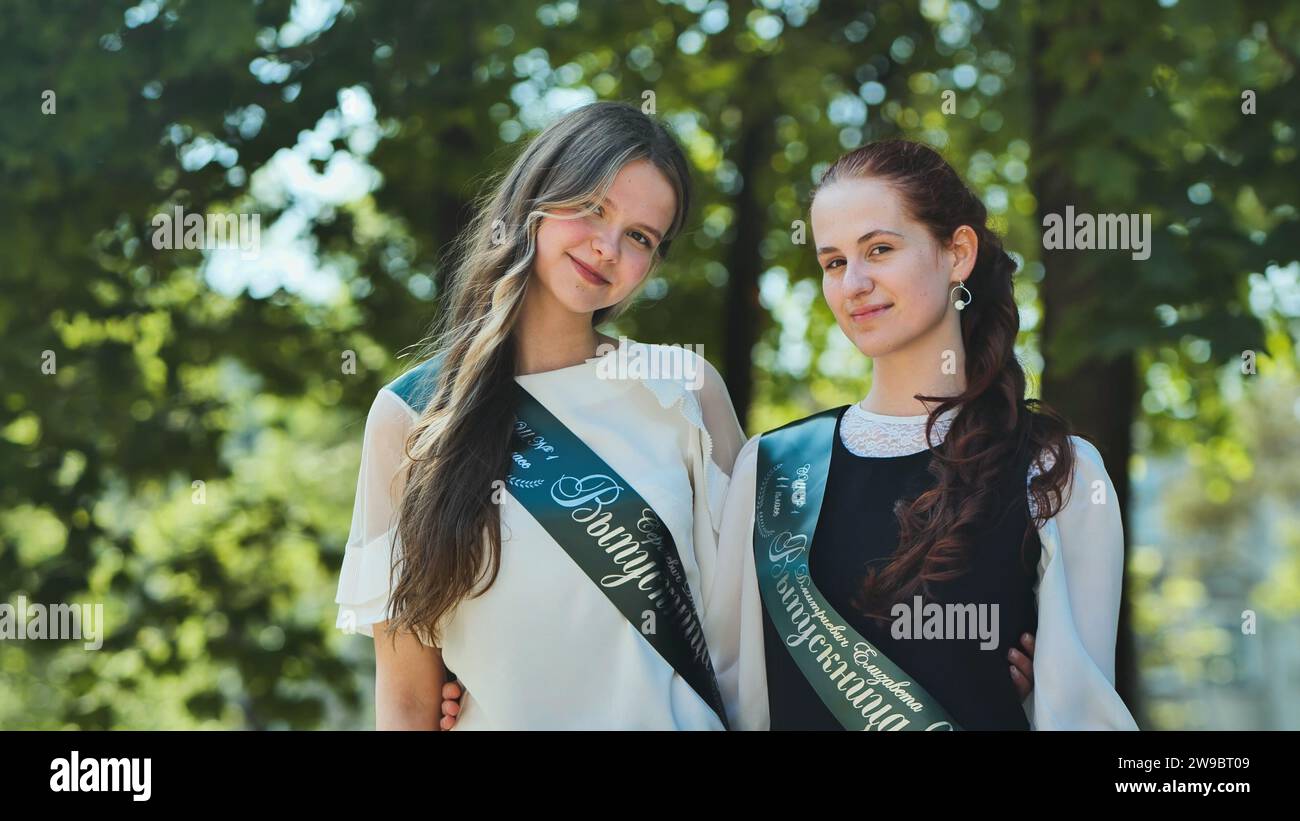 Portrait of two Russian schoolgirls graduating from high school with a ...