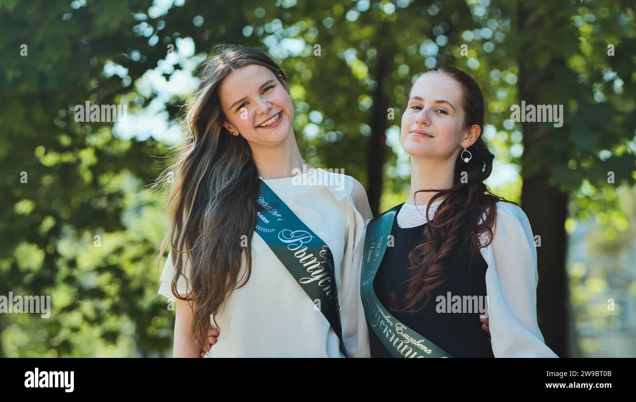 Portrait of two Russian schoolgirls graduating from high school with a ...