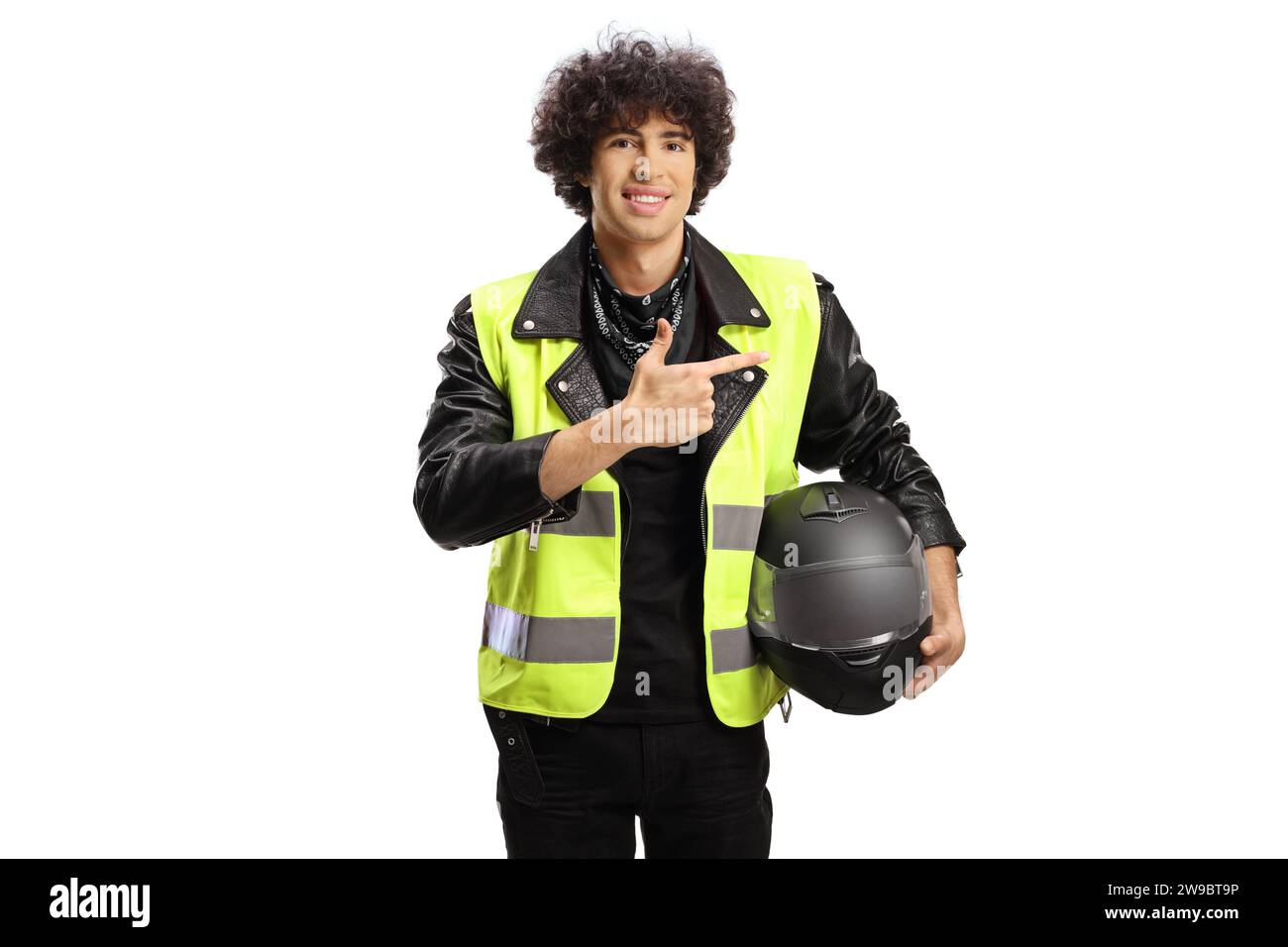 Young man holding a helmet, wearing a traffic safety vest and pointing ...