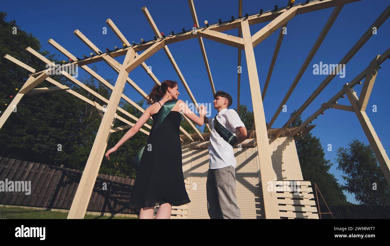 Graduating boyfriend and girlfriend dancing the school waltz in the ...