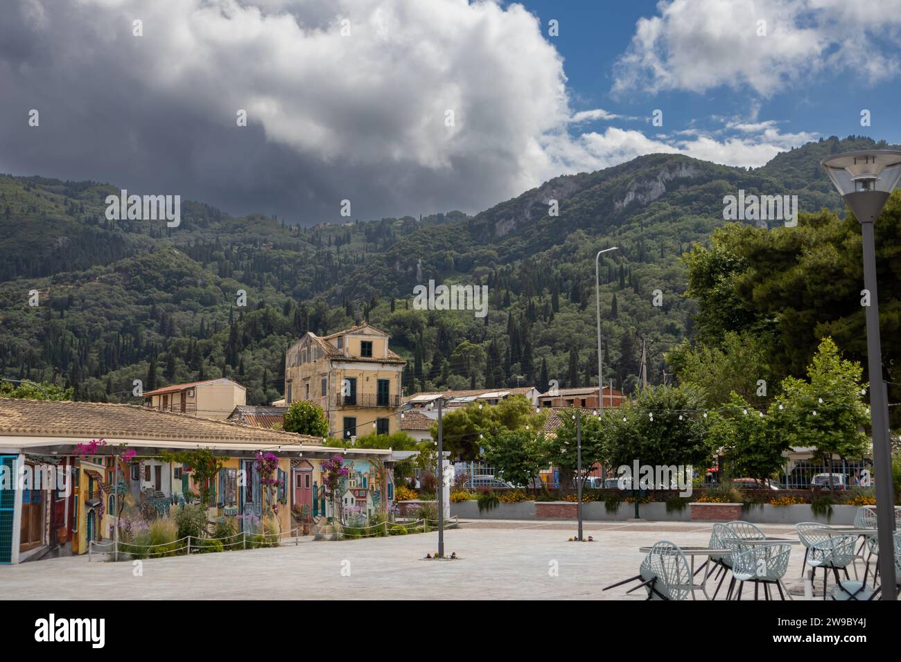 Wide promenade by the sea with restaurants and bars. Old buildings ...