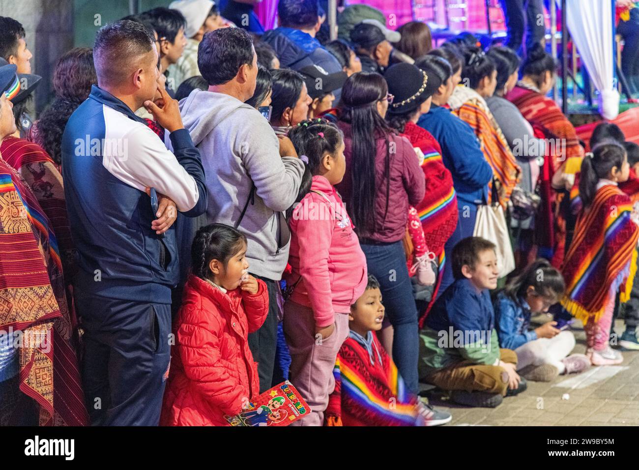 A crowd watching a ceremony procession in Aguas Calientes, Peru ...