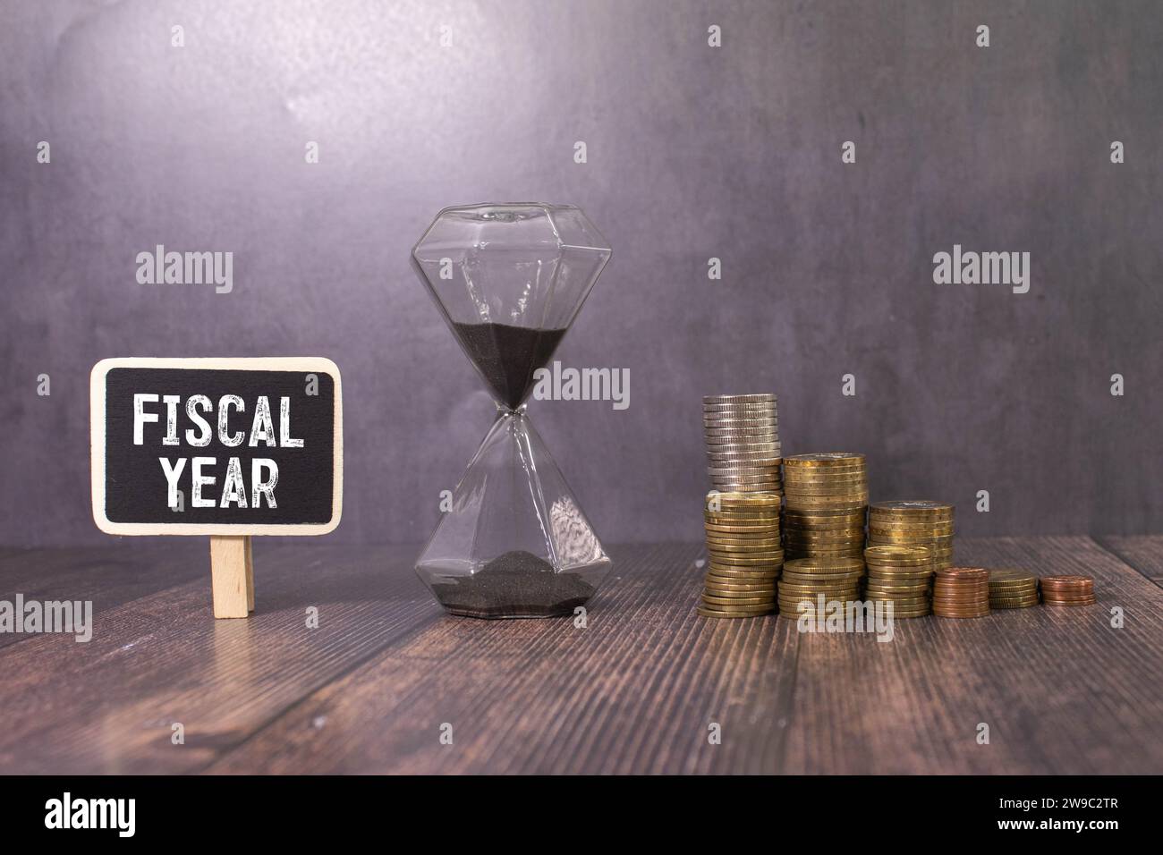 Closeup on businessman holding a card with text FISCAL YEAR, business ...