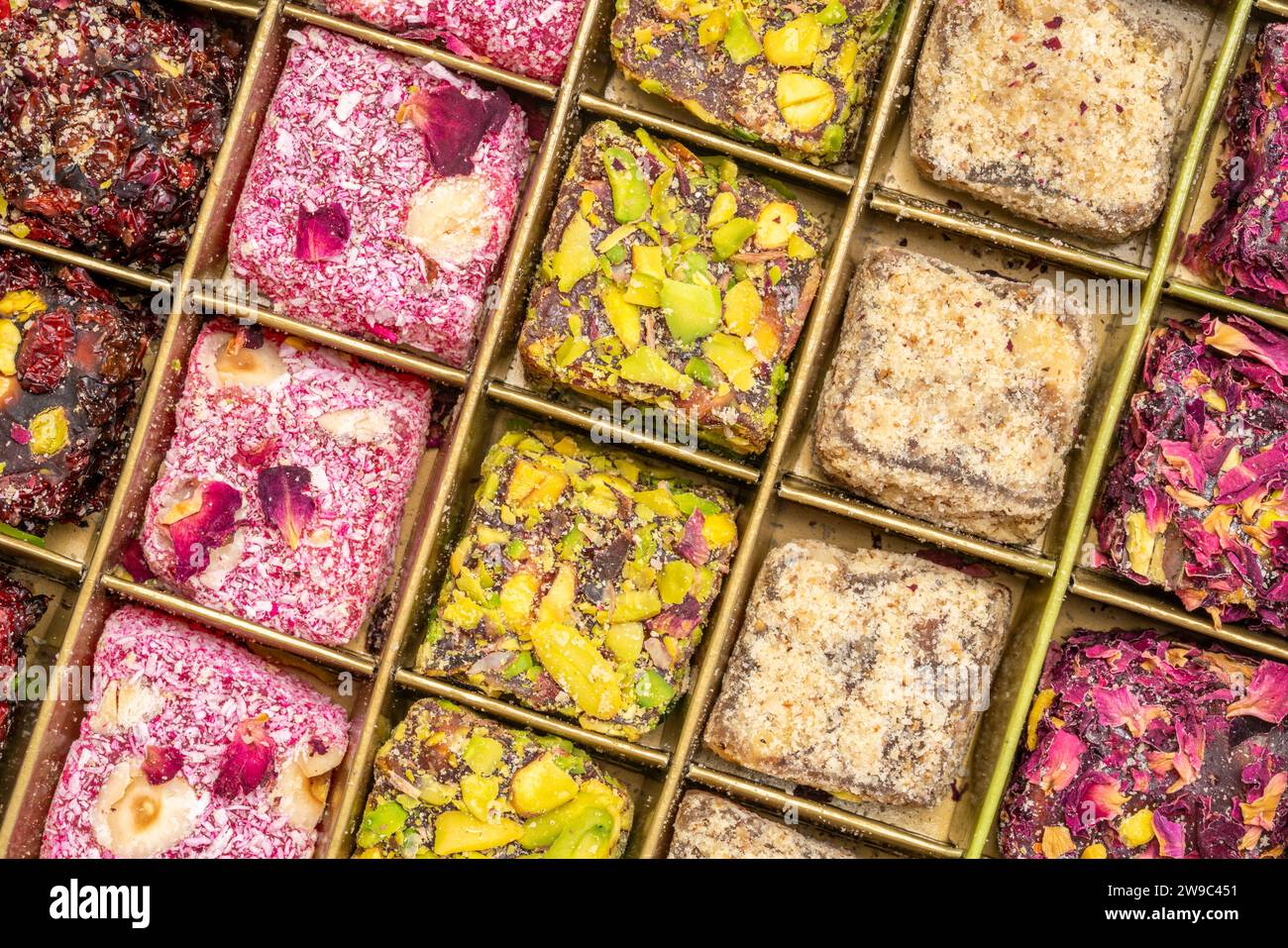 assortment of traditional Turkish delight (lokum) in a tin box against ...