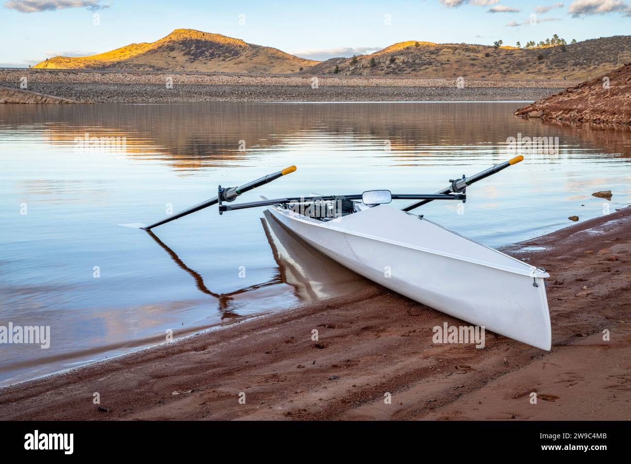 Coastal rowing shell on a shore of Horsetooth Reservoir in fall or ...