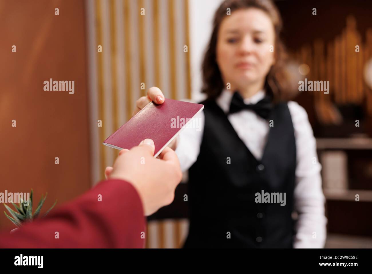 Receptionist asking for identification, taking passport from ...