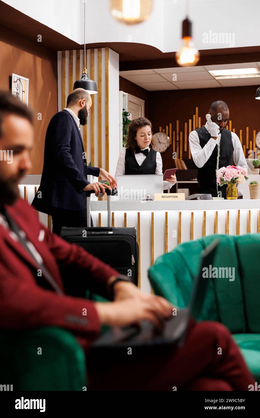 Traveling for work, businessman checking in at hotel reception desk ...
