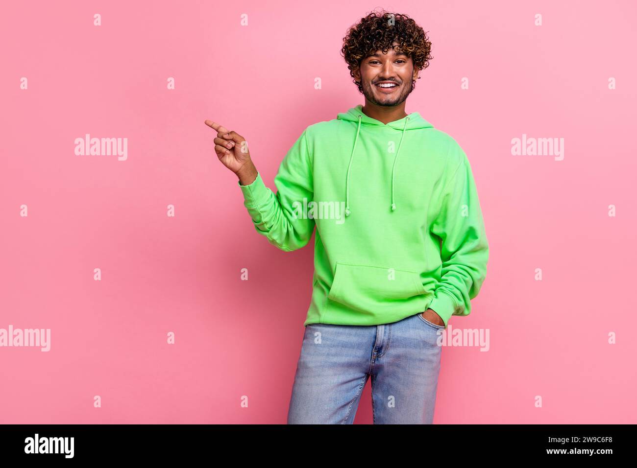 Photo of cheerful young man indian promoter pointing finger benefits ...