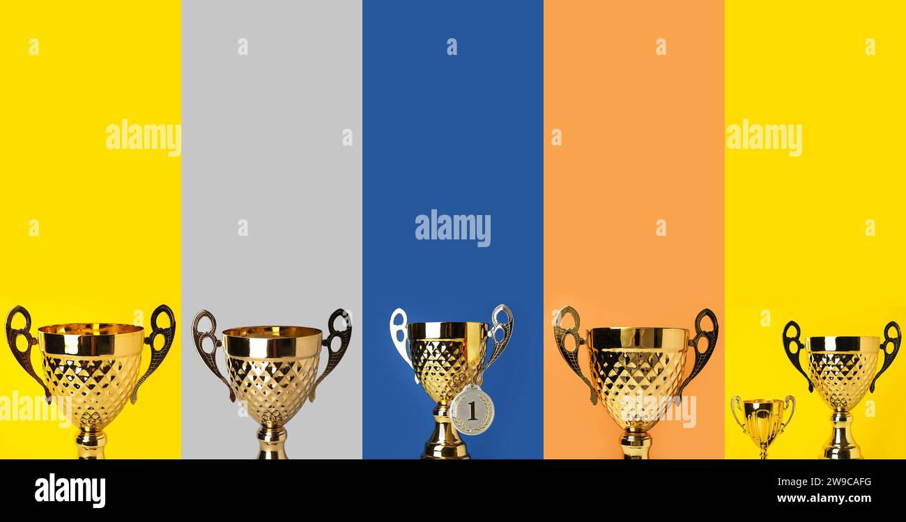Collage of golden trophy cups and medal on color background Stock Photo ...