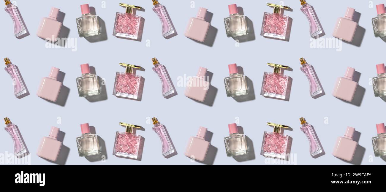 Many bottles of different perfumes on light background. Pattern for ...