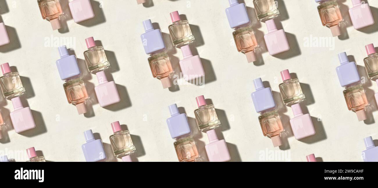 Many bottles of different perfumes on light background. Pattern for ...