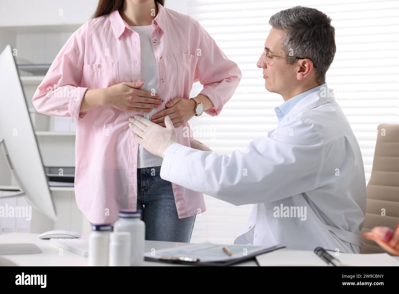 Gastroenterologist examining patient with stomach pain in clinic Stock ...