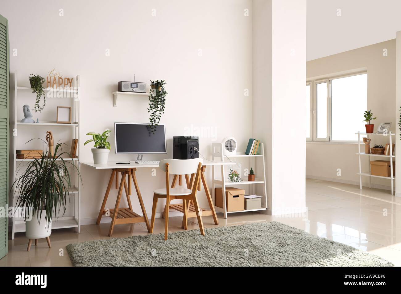 Comfortable workspace with modern computer and portable power station ...