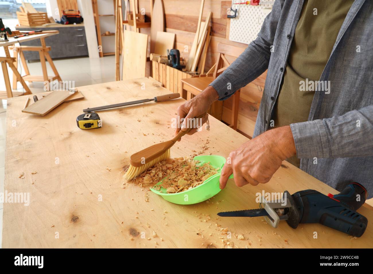 Carpenter cleaning wooden plank from hi-res stock photography and ...