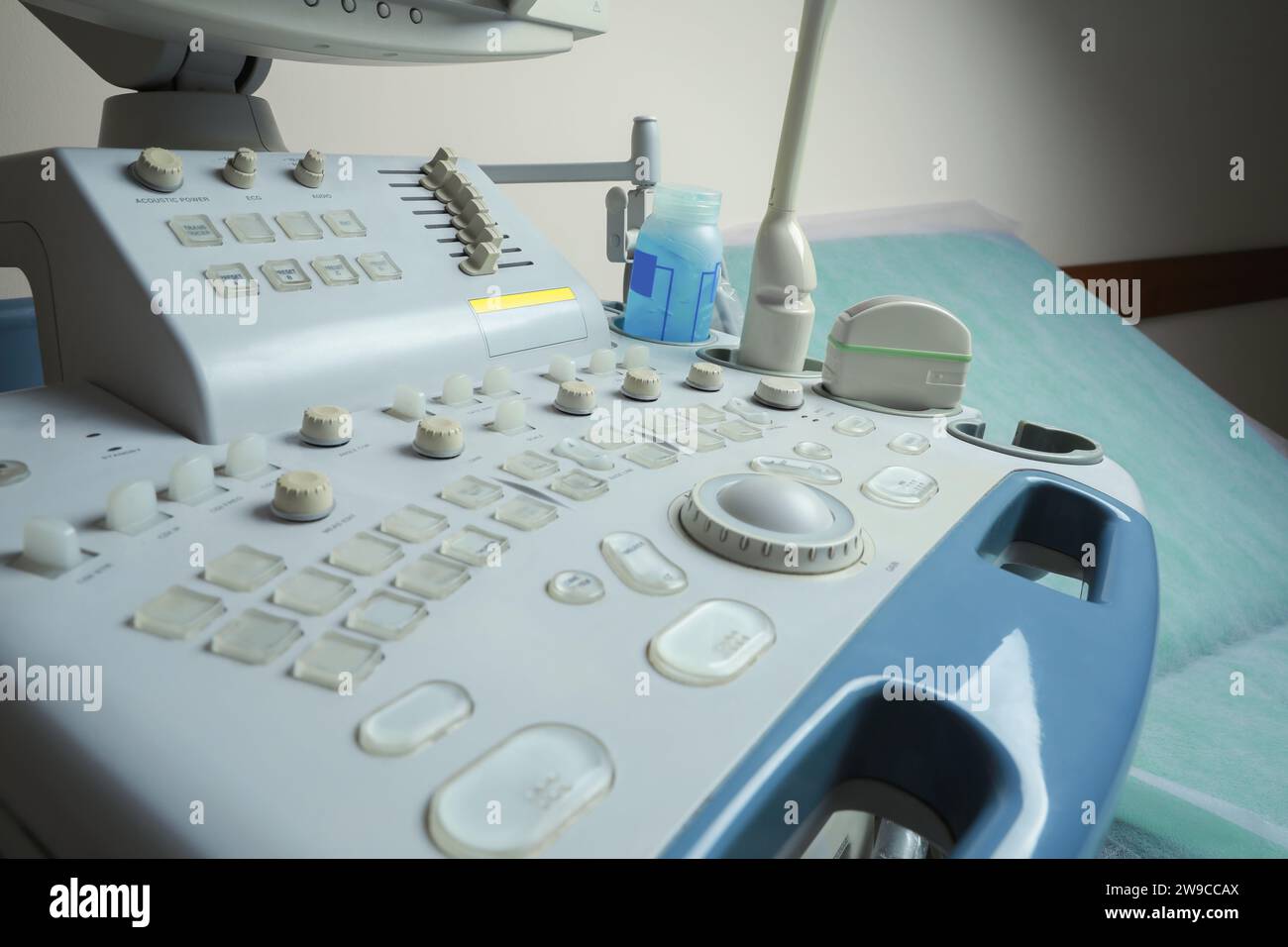 Ultrasound control panel and examination table in hospital, closeup ...