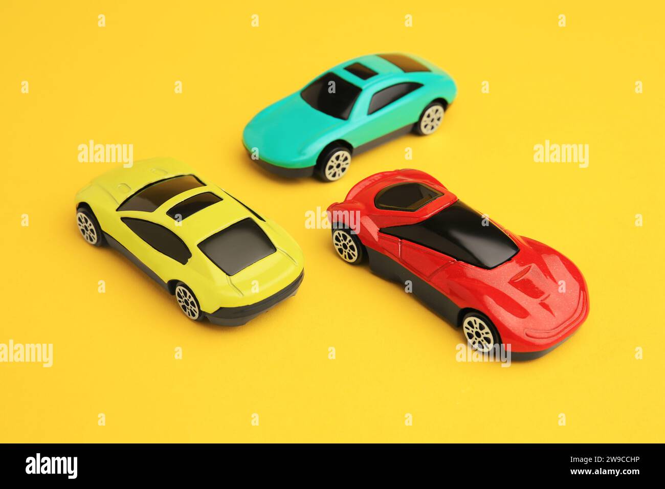 Different bright cars on yellow background. Children`s toys Stock Photo ...
