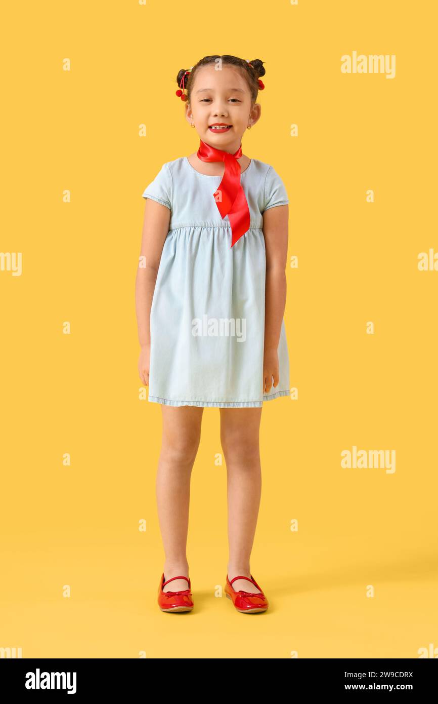 Cute little Asian girl on yellow background. Chinese New Year ...