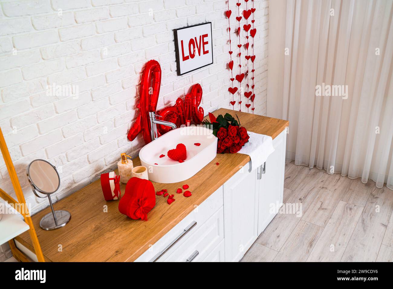Wooden counter with sink, bouquet of red roses and word LOVE made from ...