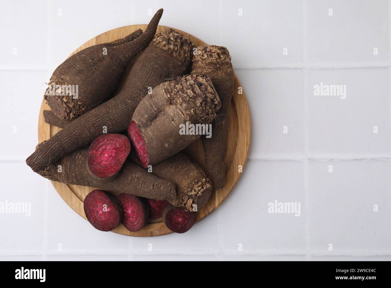 Whole and cut red beets on white table, top view. Space for text Stock ...