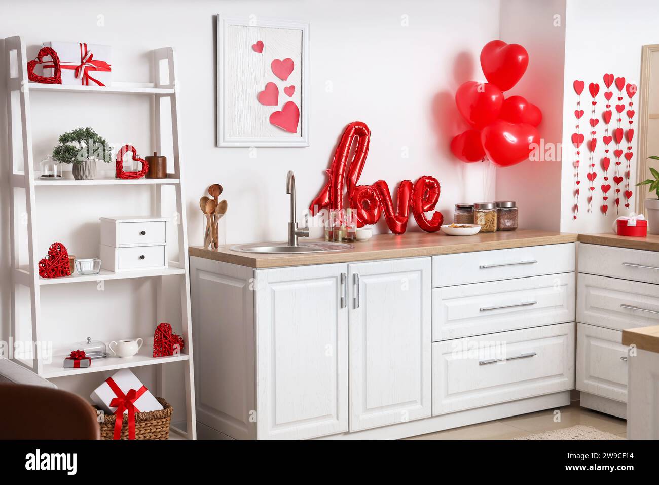 Interior of light kitchen with heart-shaped balloons and decorations ...