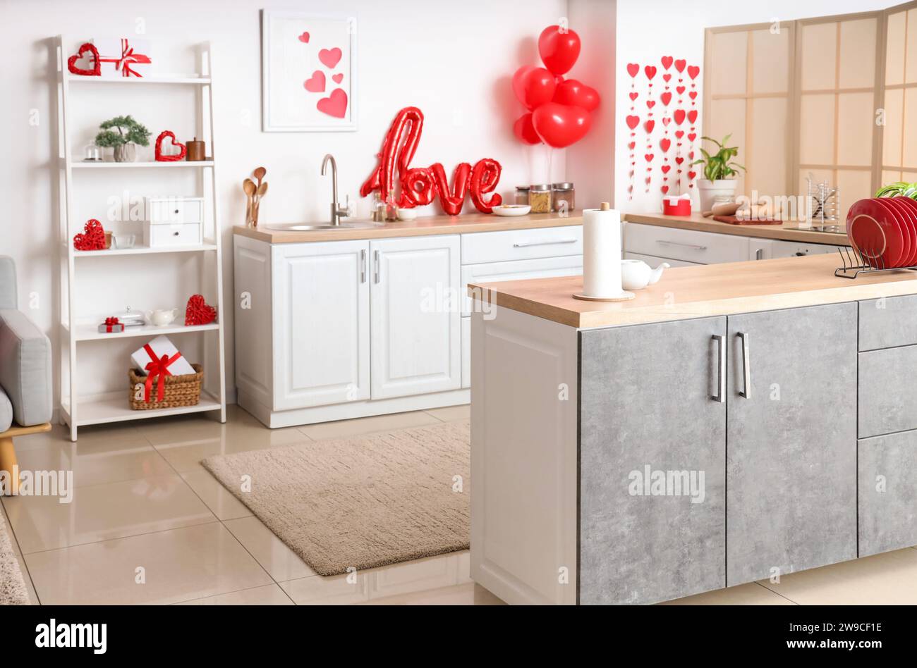 Interior of light kitchen with heart-shaped balloons and decorations ...