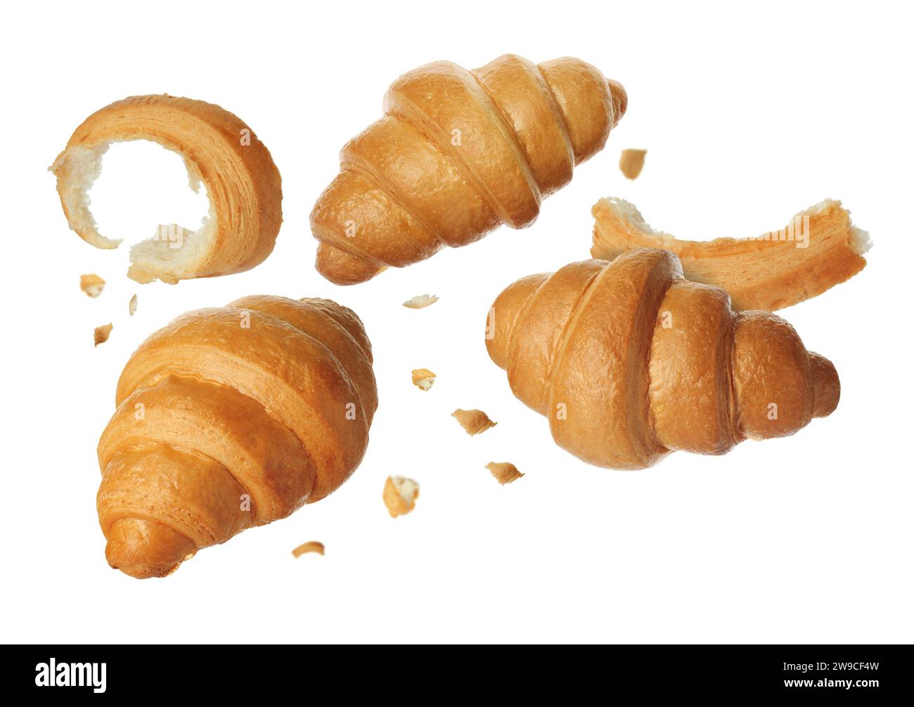 Delicious fresh croissants falling on white background Stock Photo - Alamy