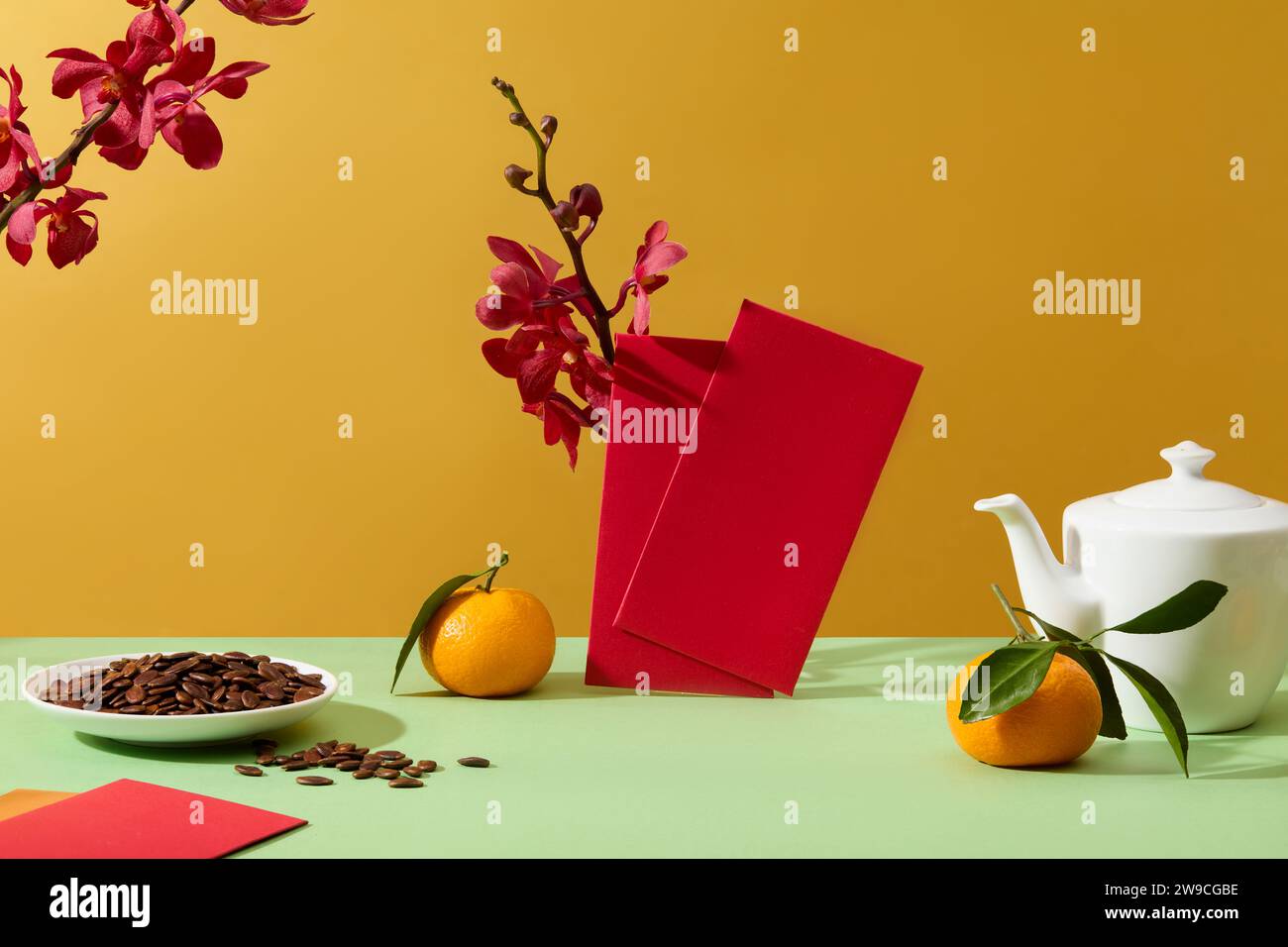 Fresh orchid branches decorate the background. A plate of melon seeds ...