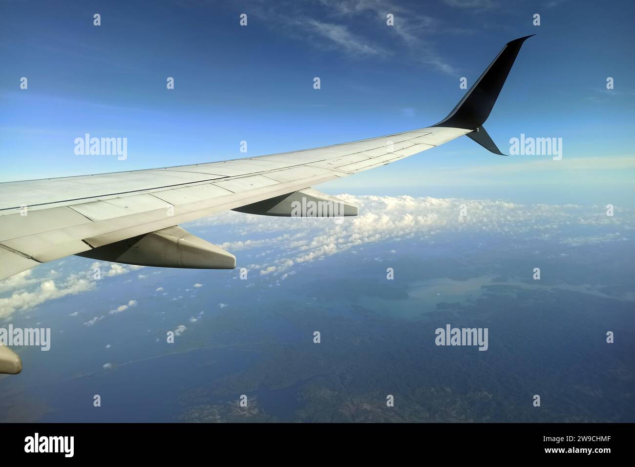 View through airplane window of commercial jet plane wing flying high ...