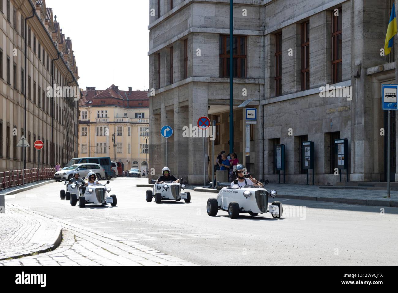 Tourists in mini hot rod go-carts drive through the streets of Prague ...