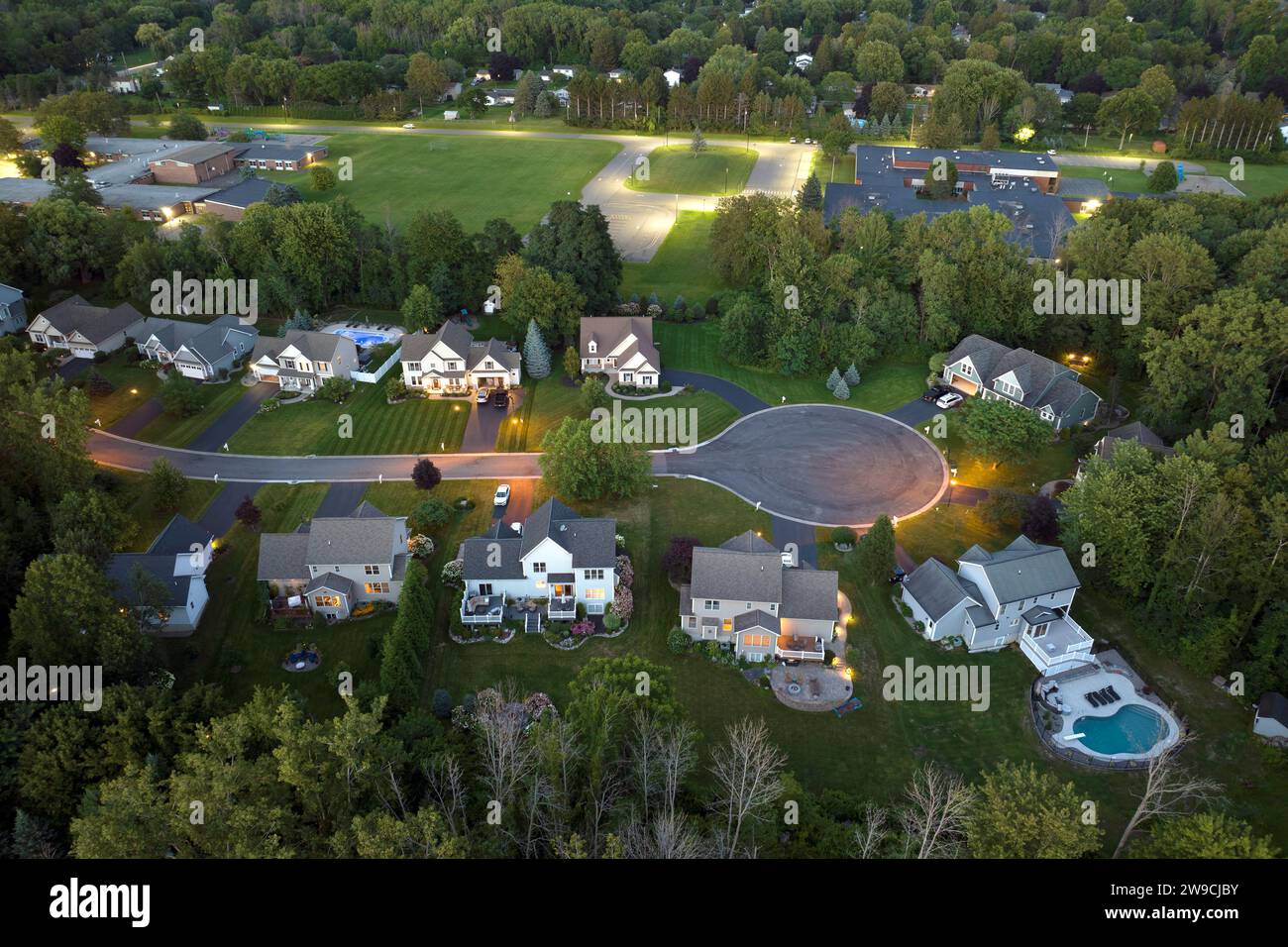 Aerial night view cul-de-sac road and spacious illuminated family ...