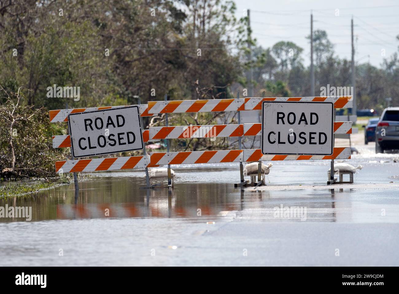 Road closed for roadworks and danger of flooding with warning signs ...