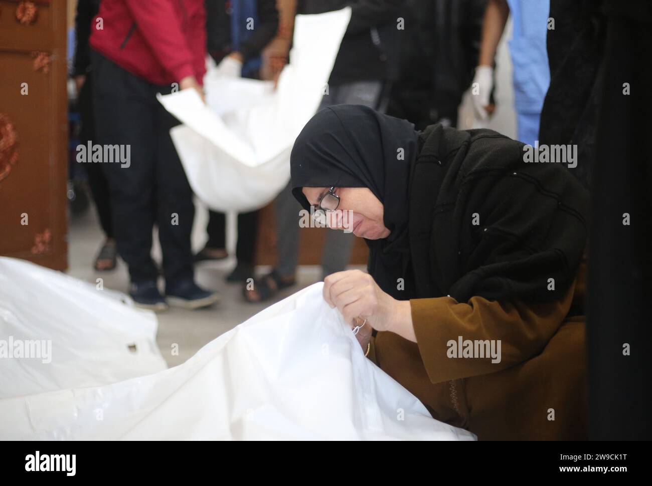 Beijing, China. 26th Dec, 2023. A woman mourns a victim at a hospital ...