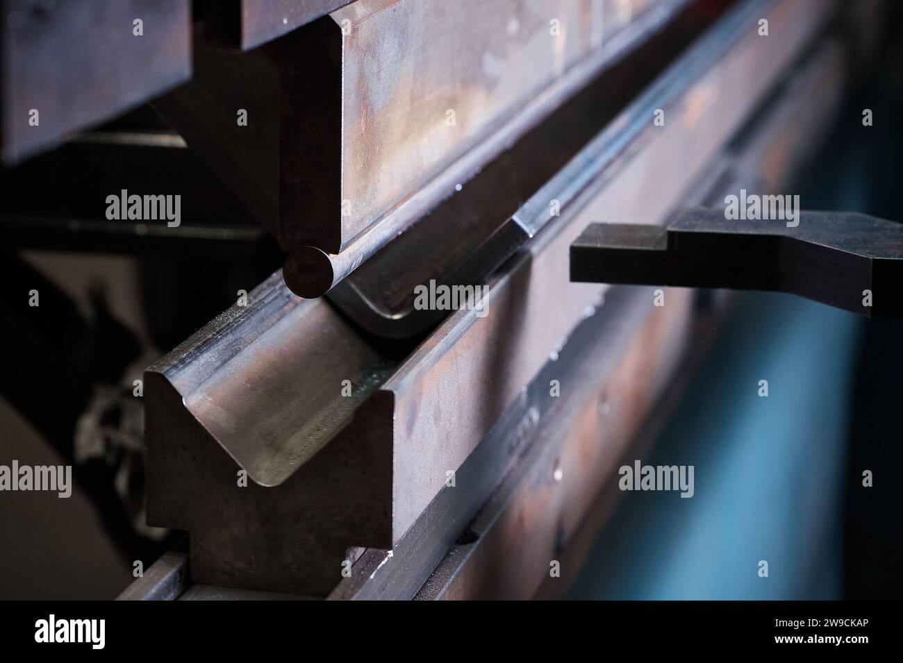 Bending press operates with metal sheet in plant workshop Stock Photo ...