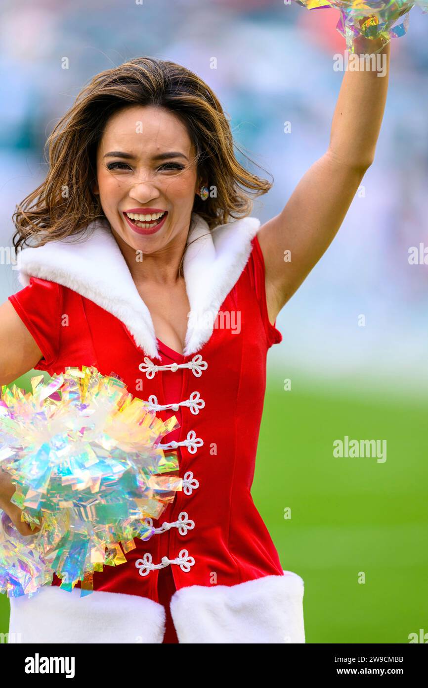 Miami Dolphins cheerleader wears a Santa jackets as she performs during ...