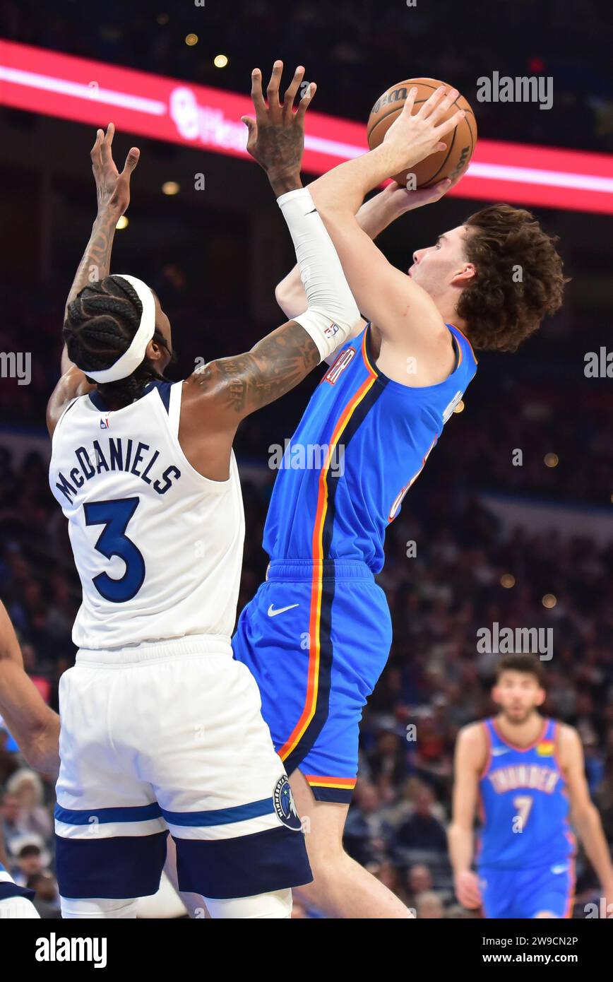 Oklahoma City Thunder guard Josh Giddey, right, shoots over Minnesota Timberwolves forward Jaden ...