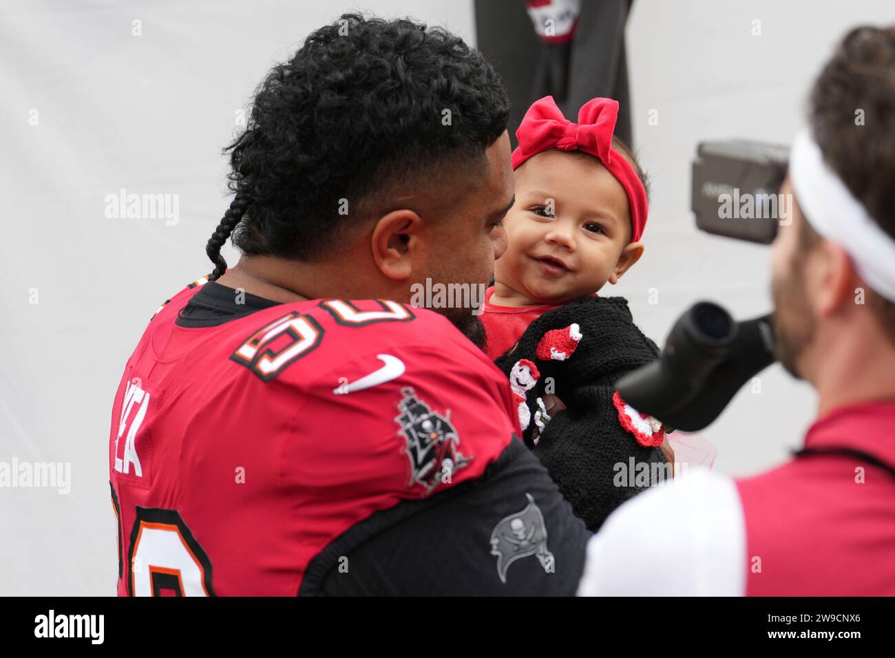 Tampa Bay Buccaneers defensive tackle Vita Vea (50) holds his daughter ...