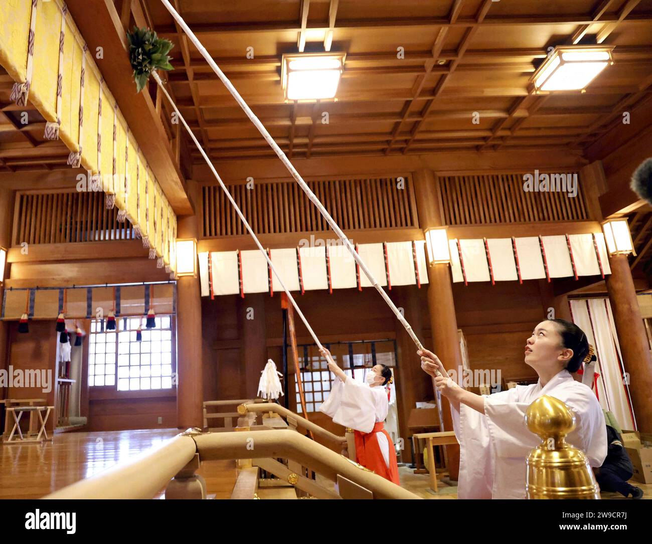 Miko san, Shrine maidens perform a susuharai by bamboo sticks to remove ...