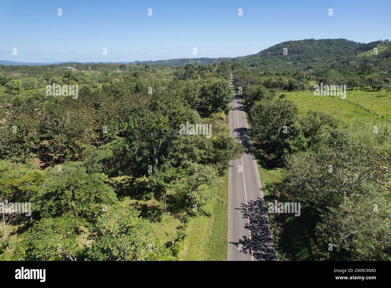Empty asphalt road aerial view in green landscape with blue sky Stock ...