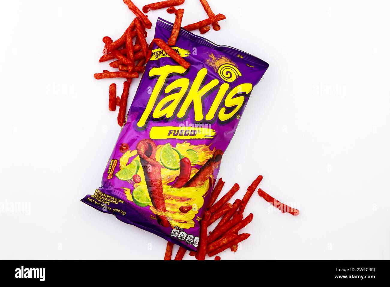 Rolling tortilla chips with chili peppers and lime by Takis Fuego Stock ...