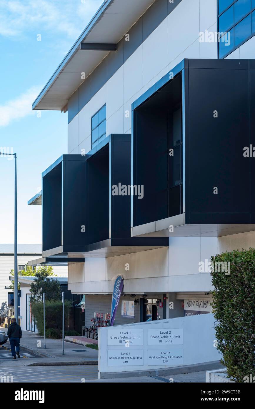 Large hoods that surround the windows of a modern warehouse in inner ...