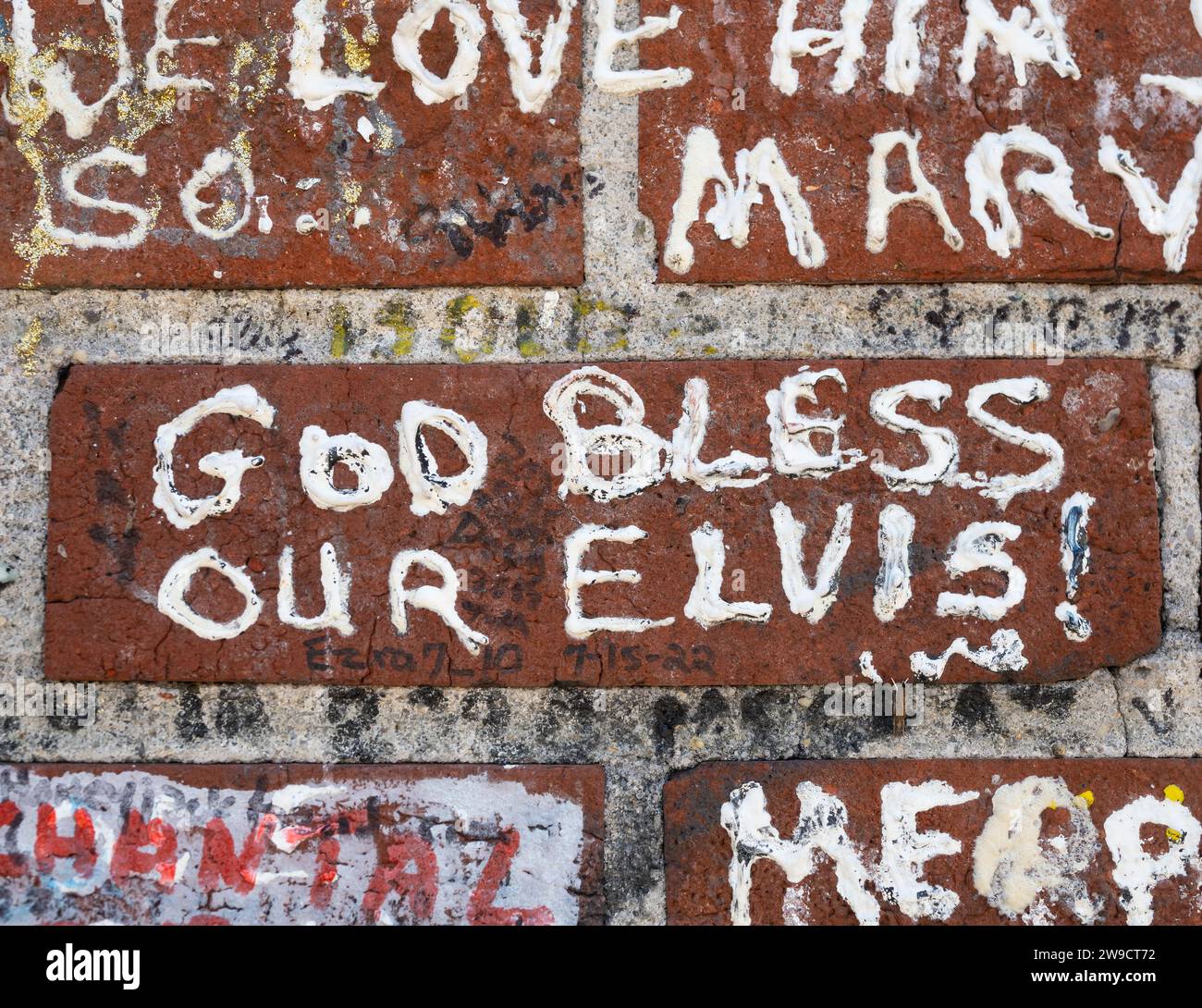 Graffiti on a brick wall that surrounds Elvis Presley's Graceland ...