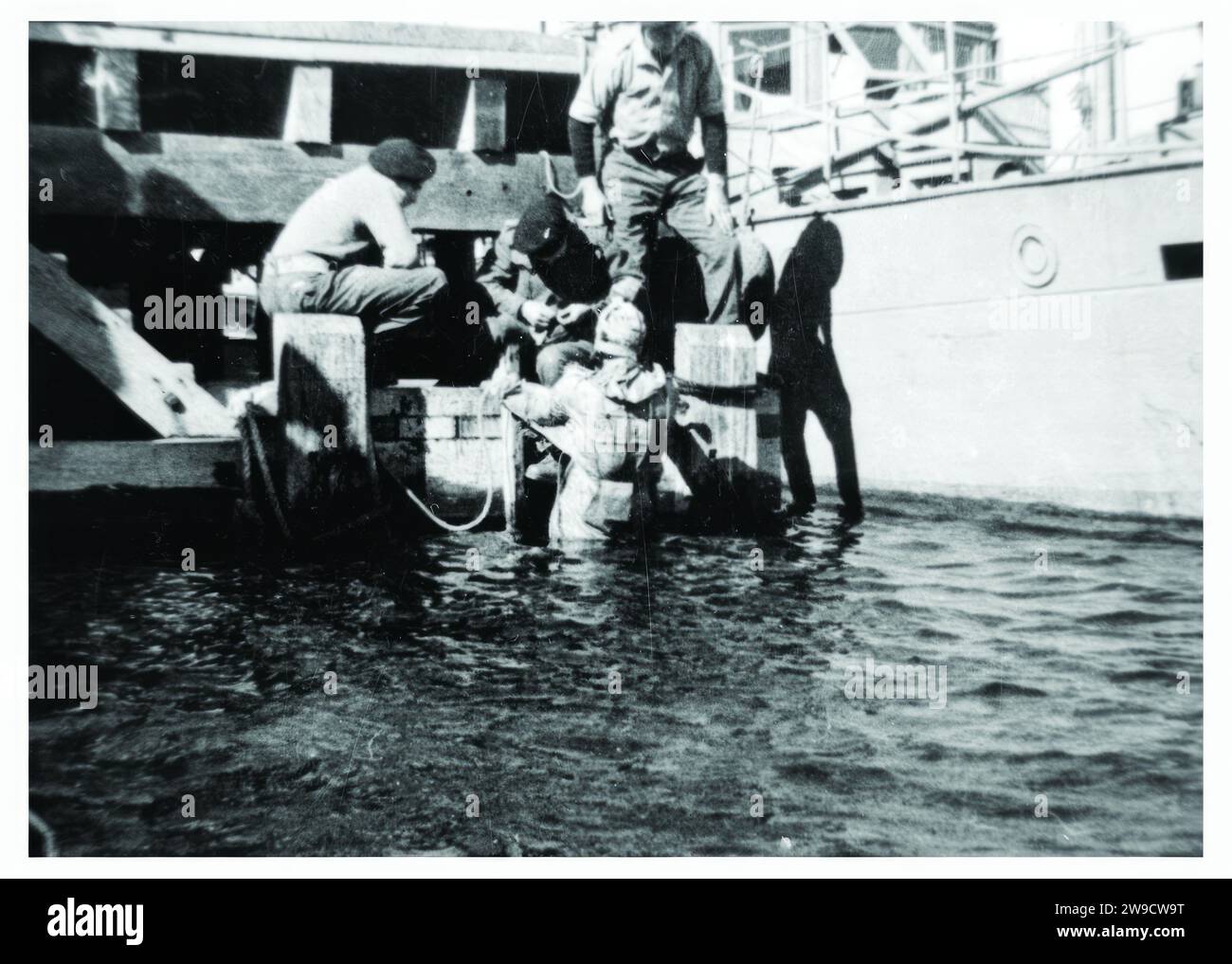 A Sleeping Beauty mini-submarine pilot enters the water to board his ...
