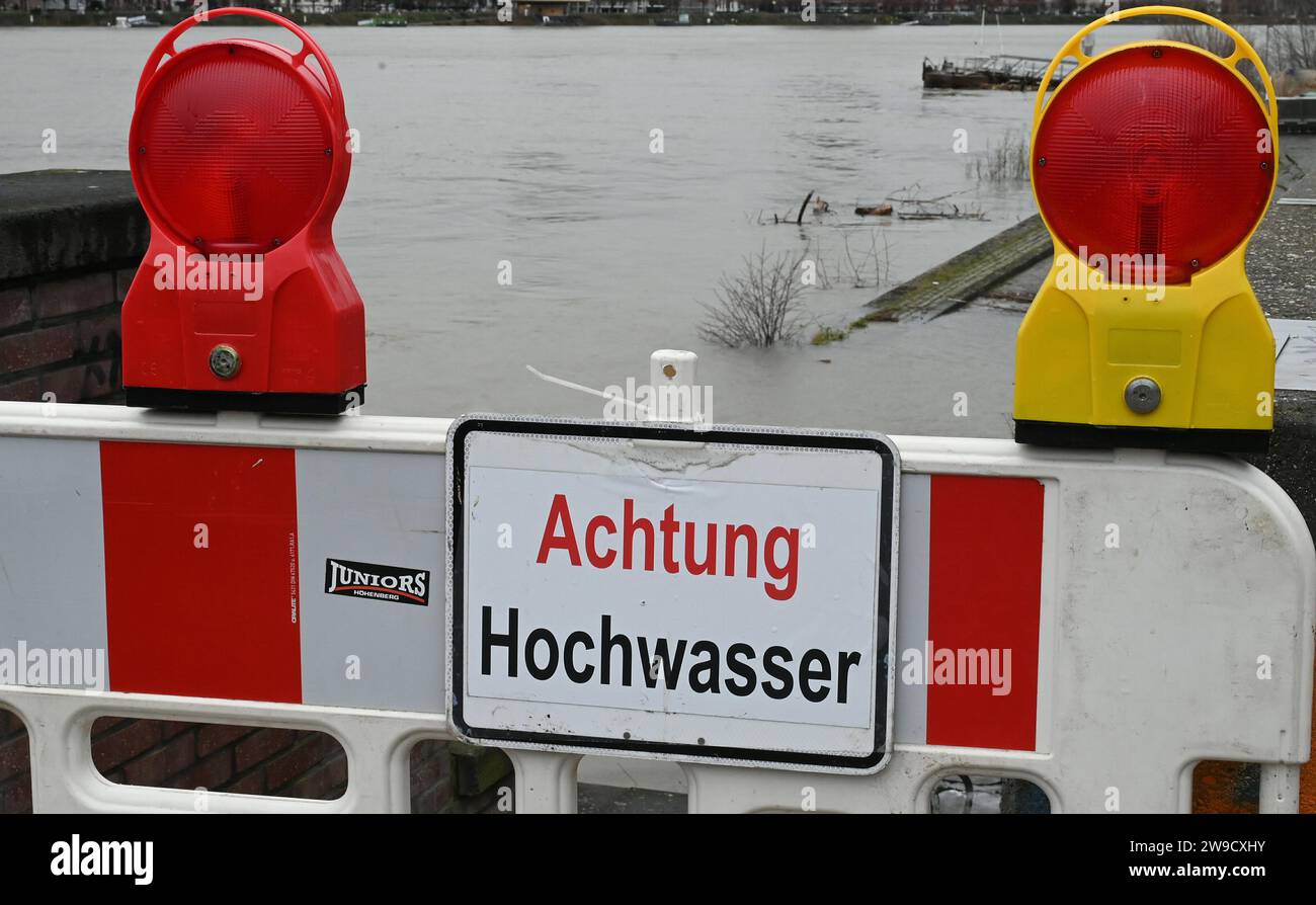 Cologne, Germany. 24th Dec, 2023. Warning sign and barrier Rhine flood ...
