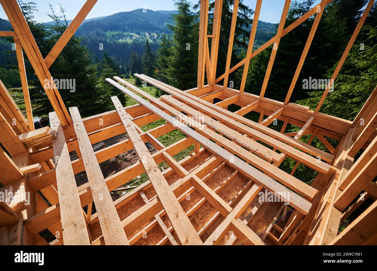 Residential wooden frame house being constructed near forest. Start of ...