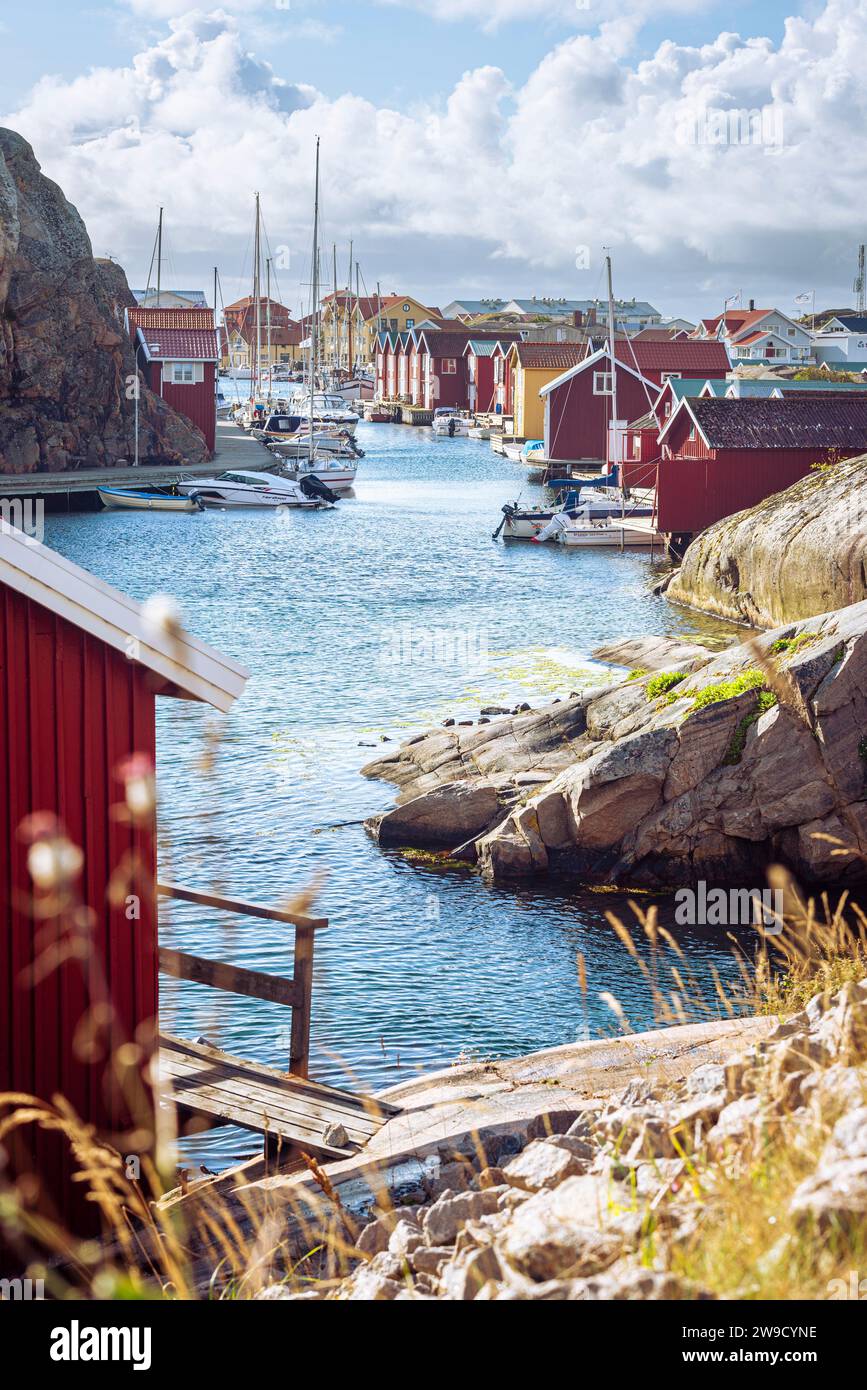Boat sheds and warehouses with red wooden facades and granite rocks in ...