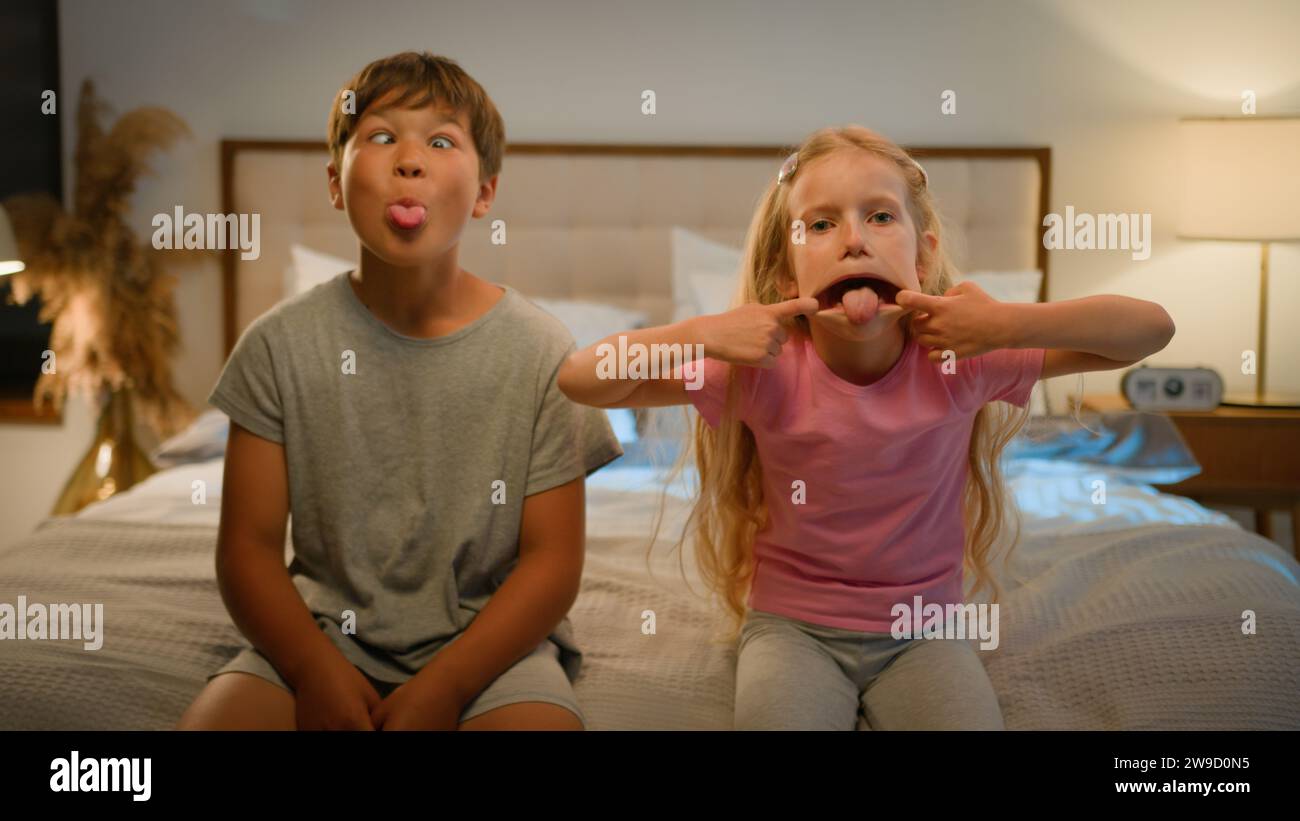 Girl making funny faces at boy hi-res stock photography and images - Alamy