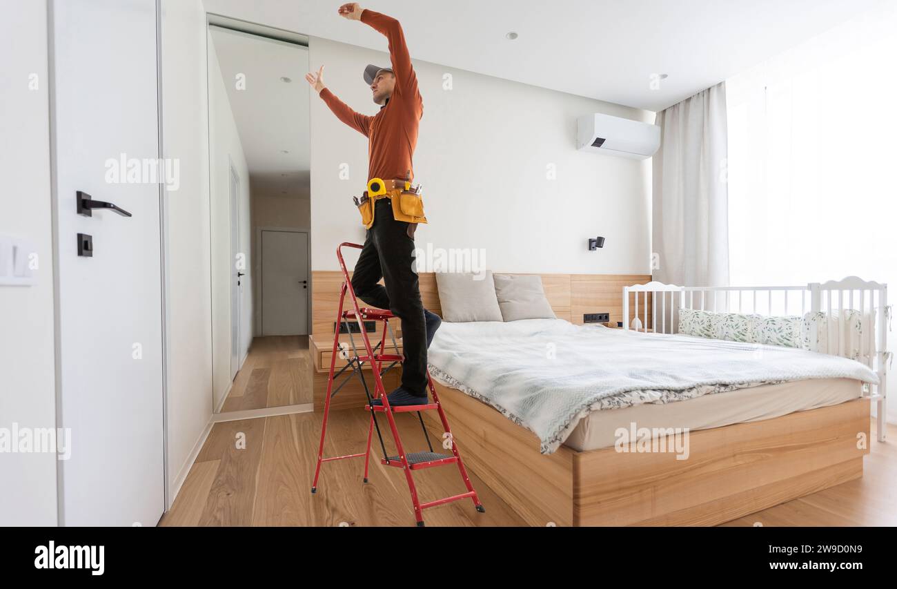 working man is working on repairs Stock Photo - Alamy