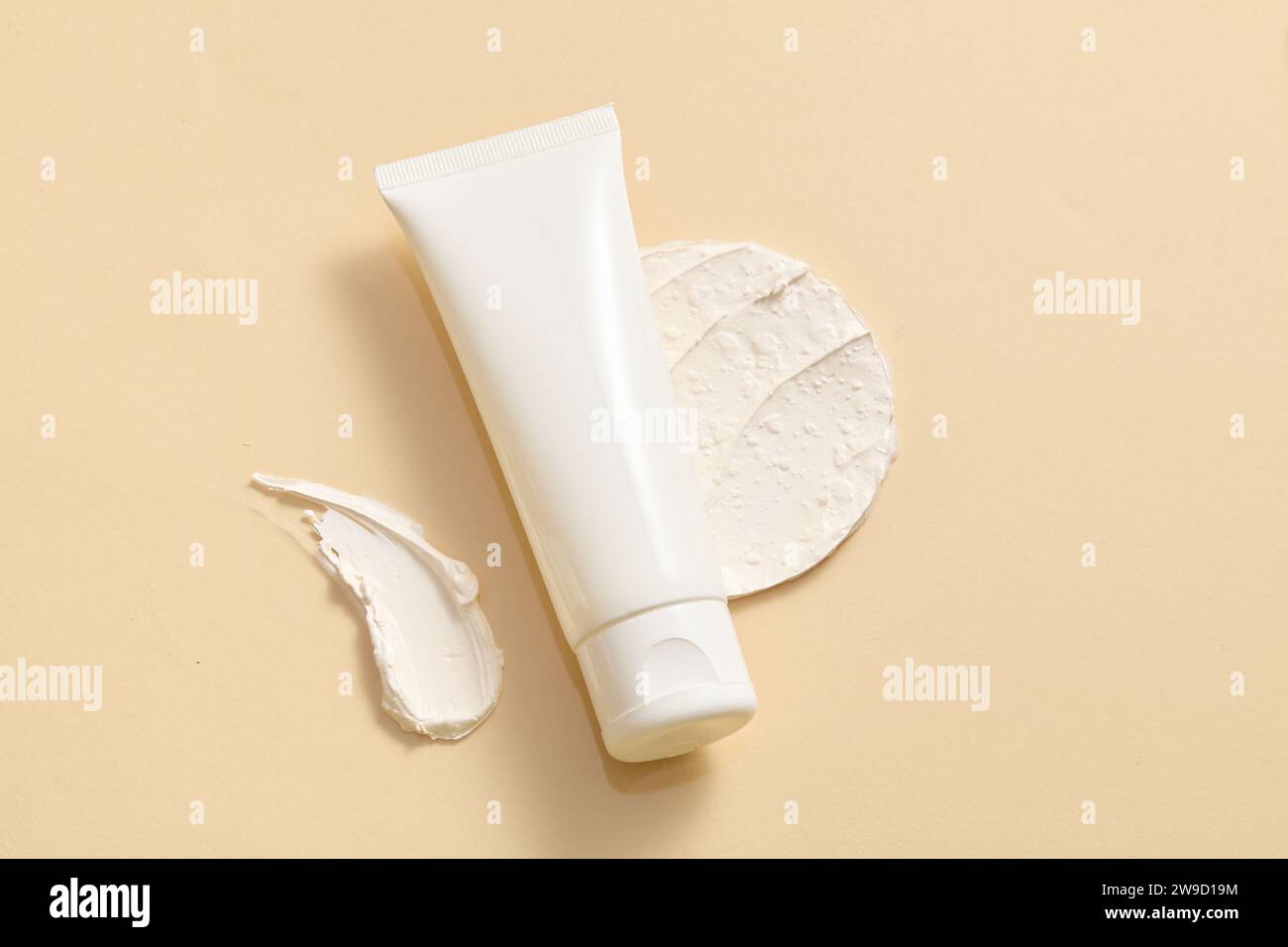 White exfoliation cream smear smudge sample decorated on beige ...