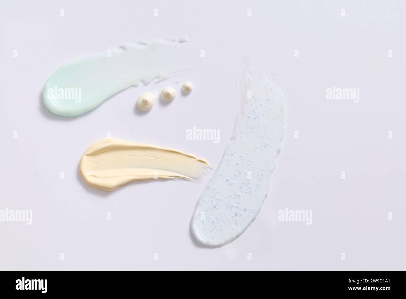 Different cosmetic textures of face cream, serum and exfoliating cream ...