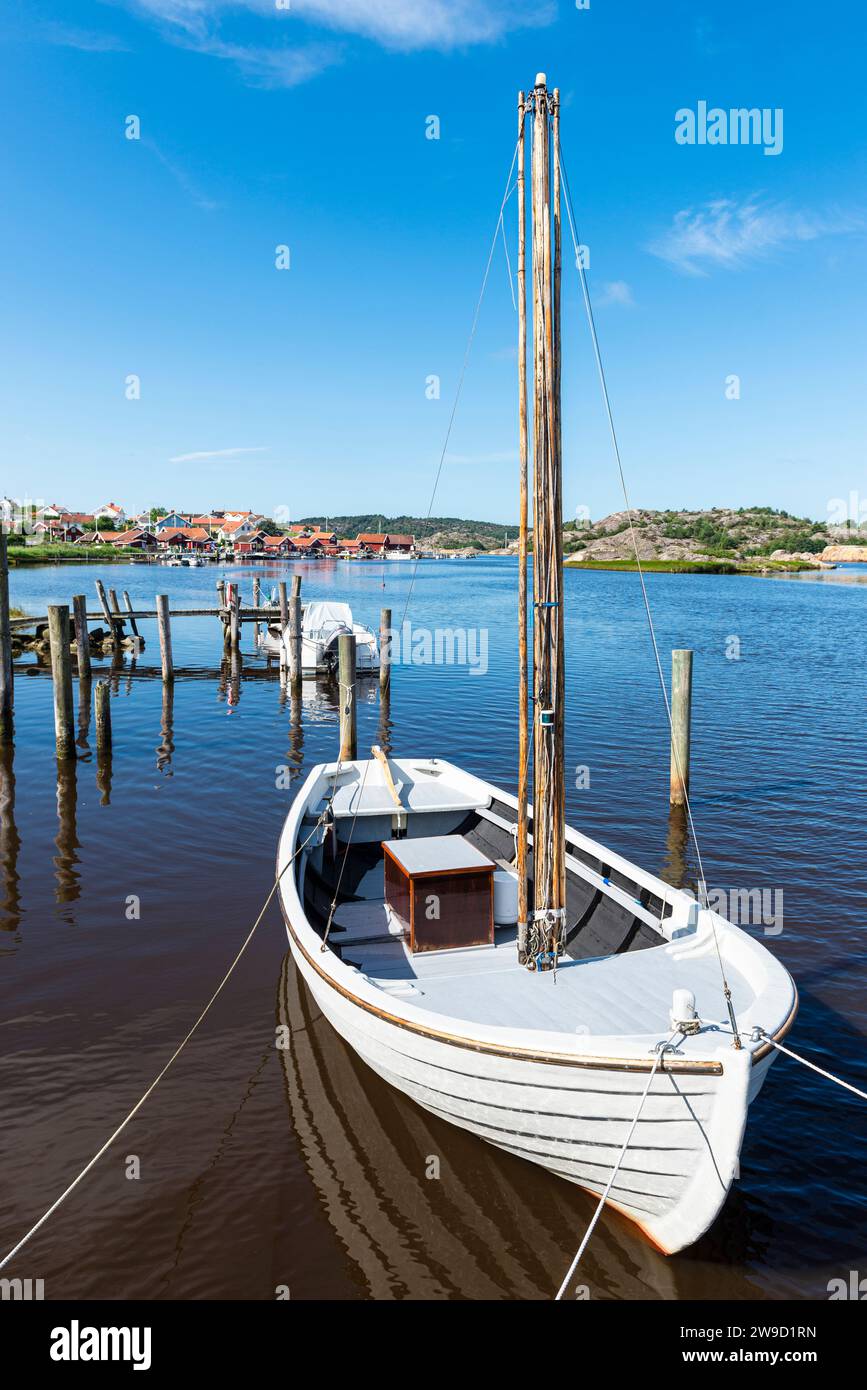 White wooden sailing boat moored at the jetty in the sunshine in the ...